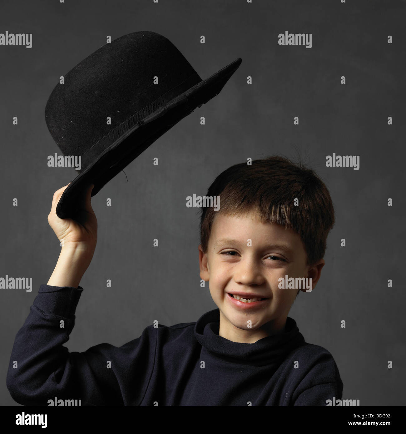 Young boy poses with assorted hats, straw, construction, hard, top ...
