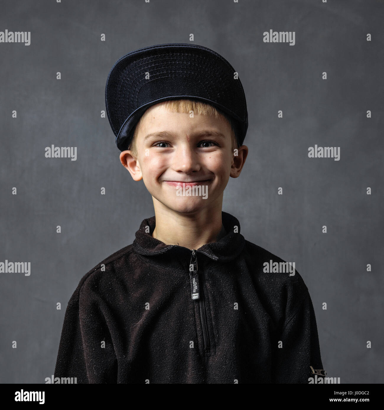 Young boy poses with assorted hats, straw, construction, hard, top ...