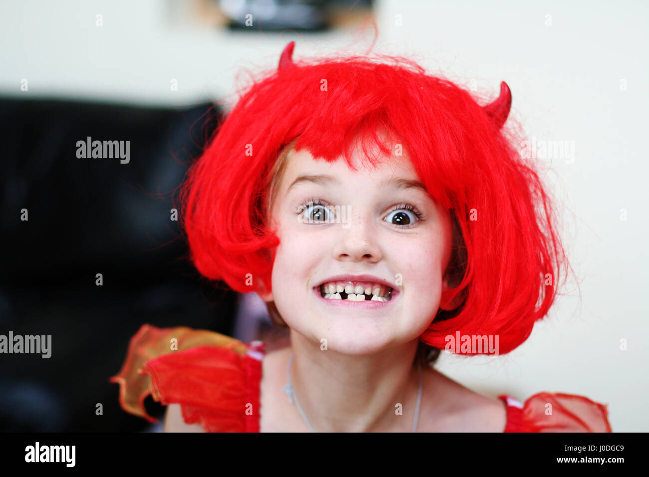 Child dressed in a Devil costume red horns and wig, kids halloween ...