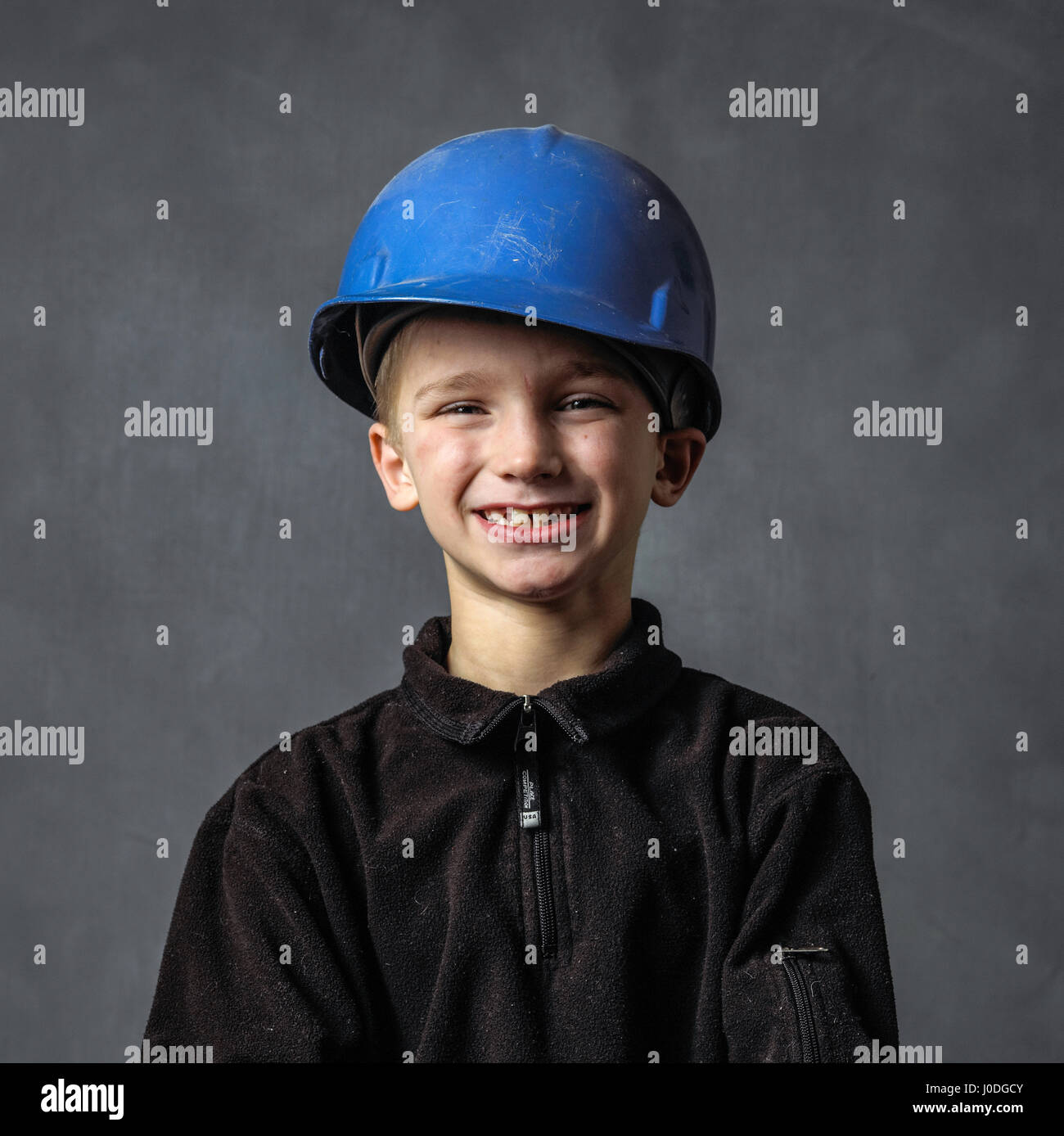 Young boy poses with assorted hats, straw, construction, hard, top ...