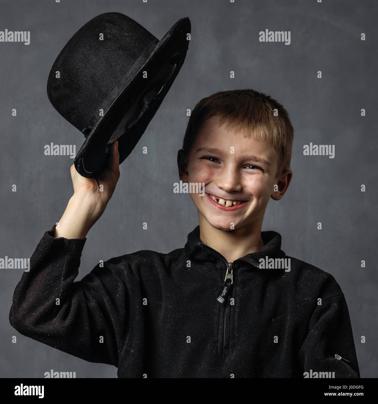 Young boy poses with assorted hats, straw, construction, hard, top ...