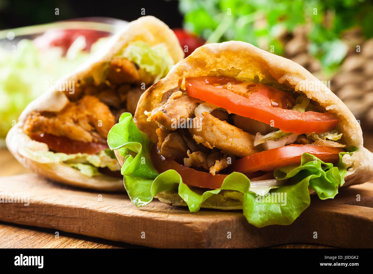 Doner kebab - fried chicken meat with vegetables in pita bread Stock ...