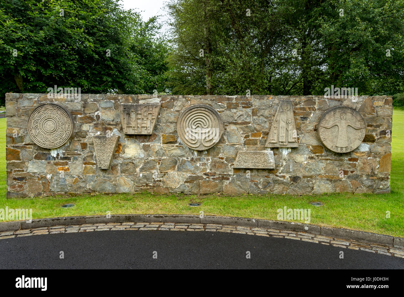 Sculpted religious symbols on a wall at the Church of St. Aengus, Burt ...