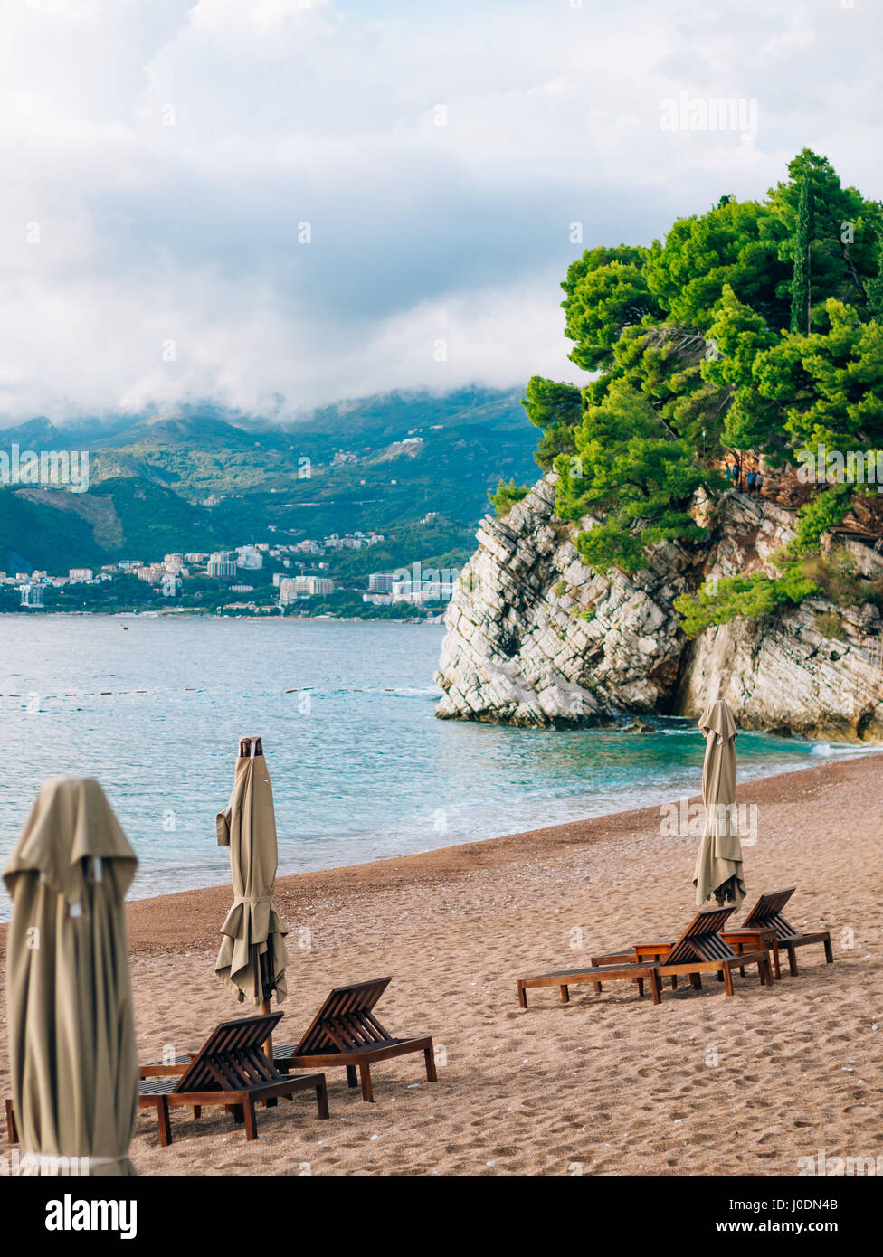 Sun beds and umbrellas on the beach. Montenegrin beaches of the Stock ...