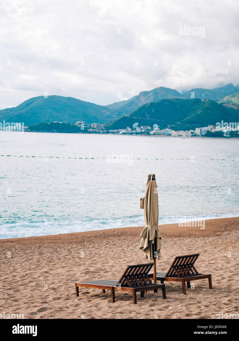 Sun beds and umbrellas on the beach. Montenegrin beaches of the Stock ...