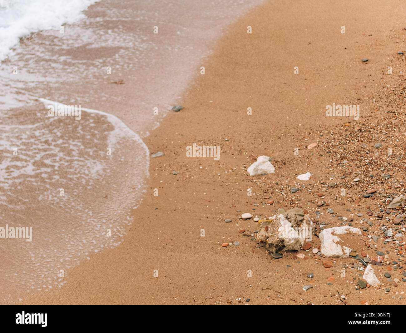 Sandy beach and waves, close-up. Texture of sand and water. Pict Stock ...