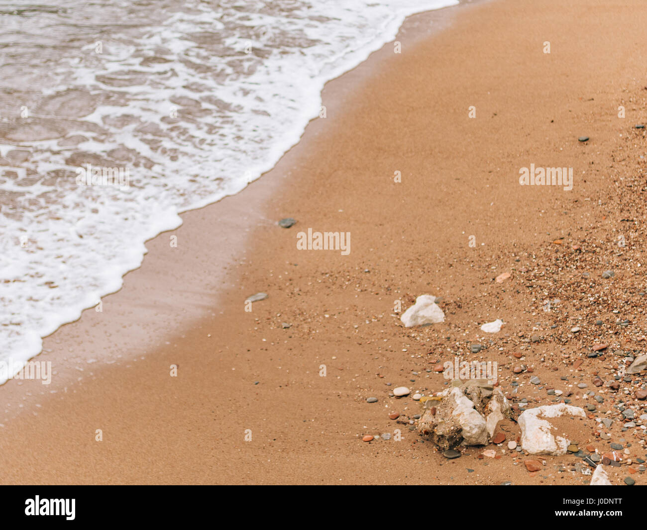 Sandy beach and waves, close-up. Texture of sand and water. Pict Stock ...