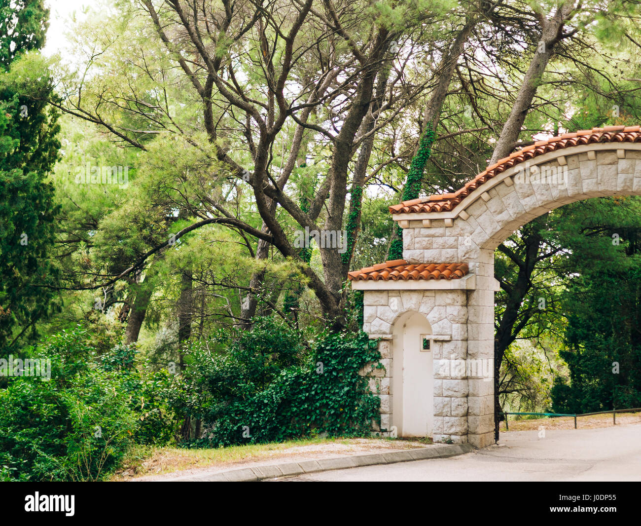 Stone Gate with a tiled roof in the forest. Handmade. Exterior d Stock ...