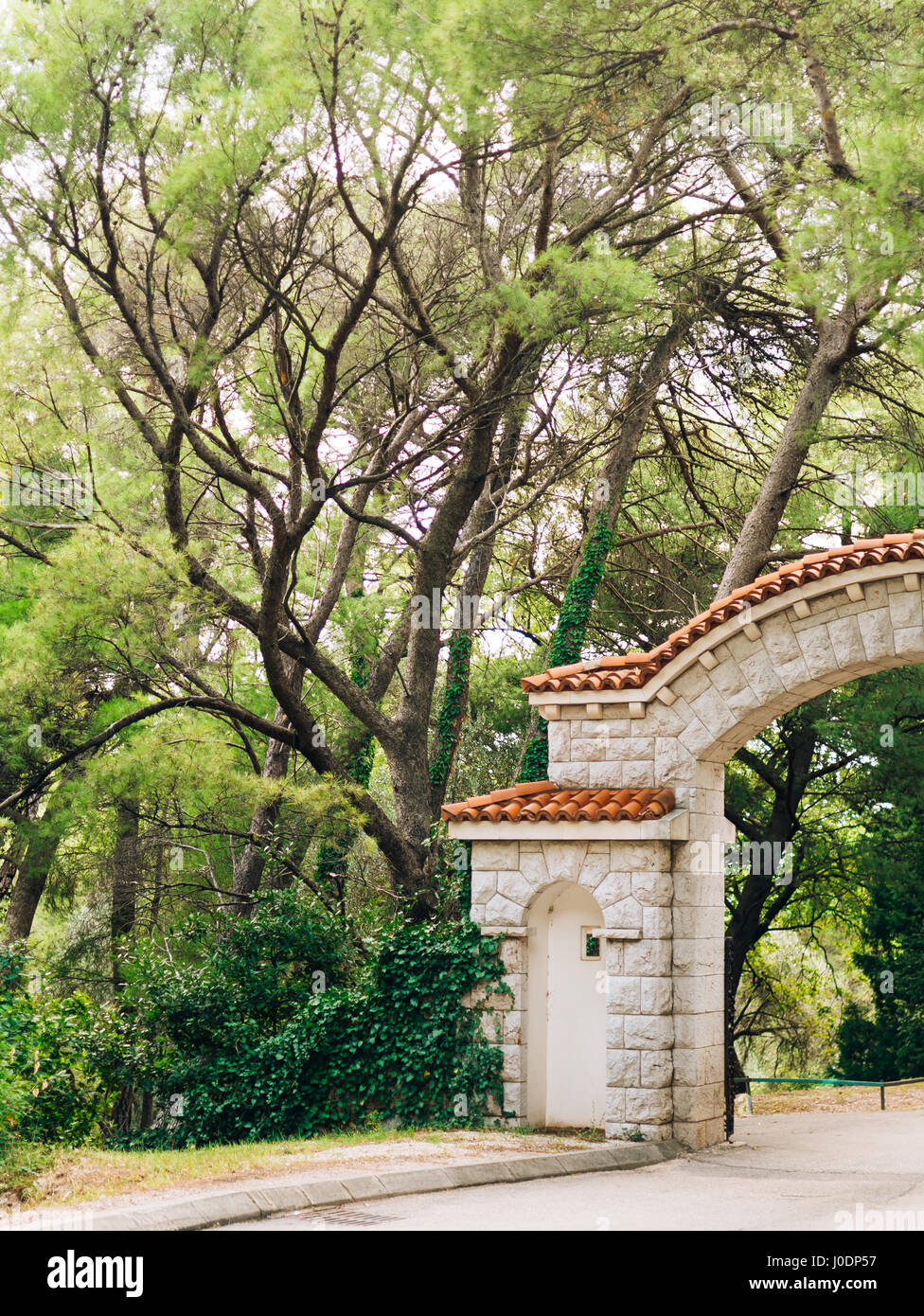 Stone Gate with a tiled roof in the forest. Handmade. Exterior d Stock ...