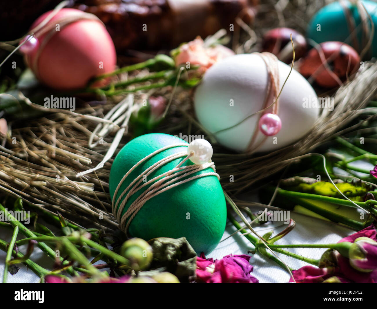 Easter dyed eggs laid on hay Stock Photo - Alamy