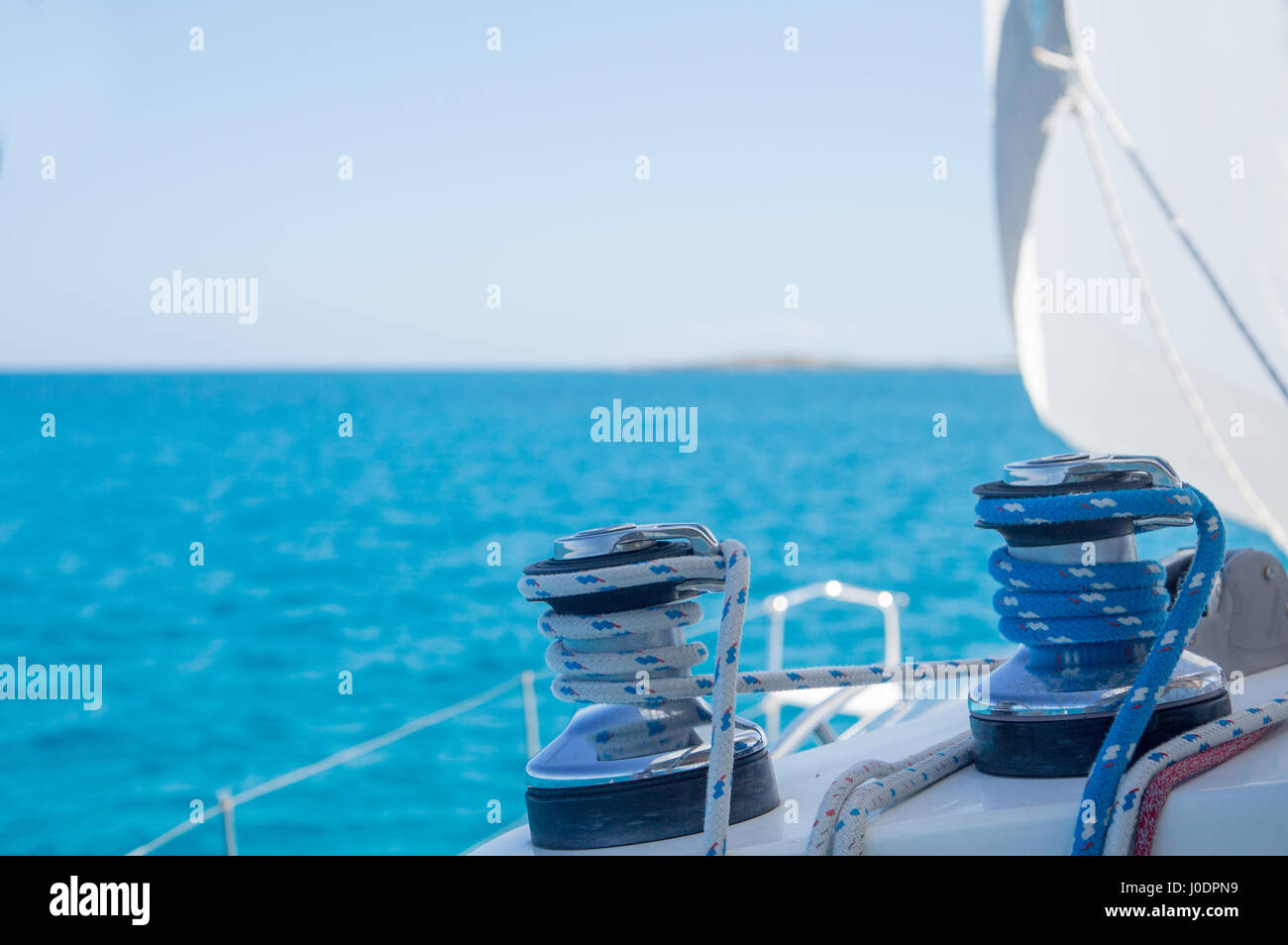 Sailing on a calm blue sea. Lines, ropes, winches, sails and rigging on ...