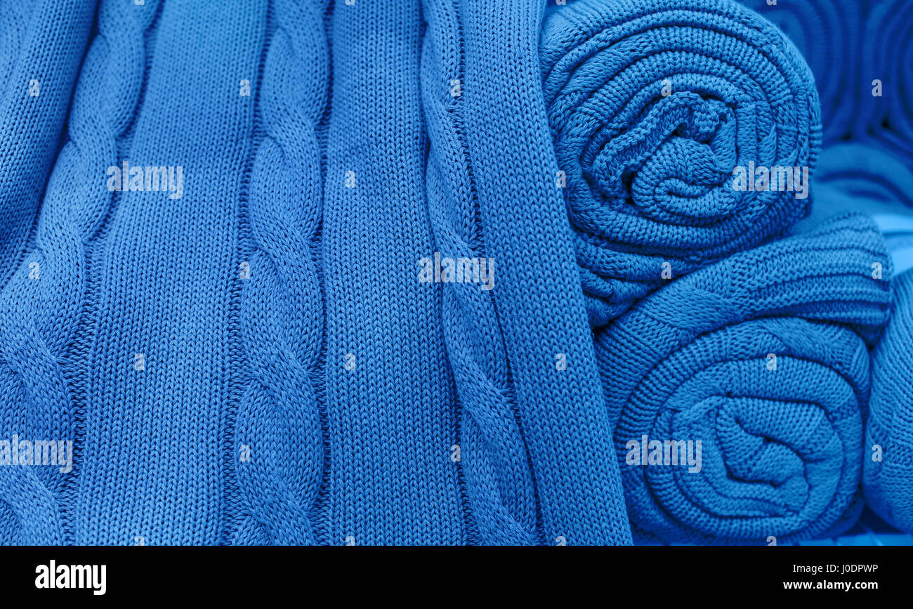 Blue knitted fabric twisted into a roll Stock Photo - Alamy