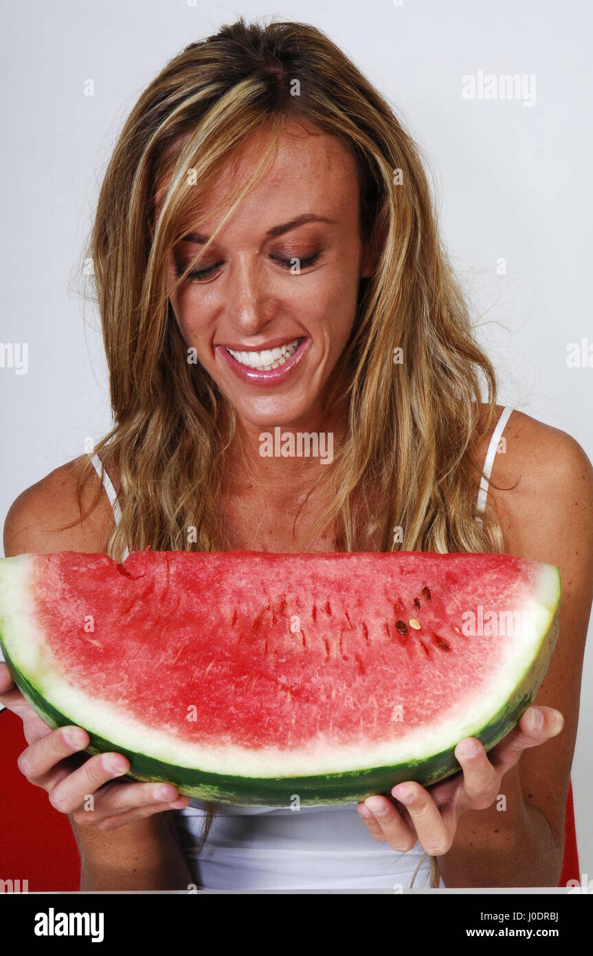 A woman eating a watermelon Stock Photo - Alamy