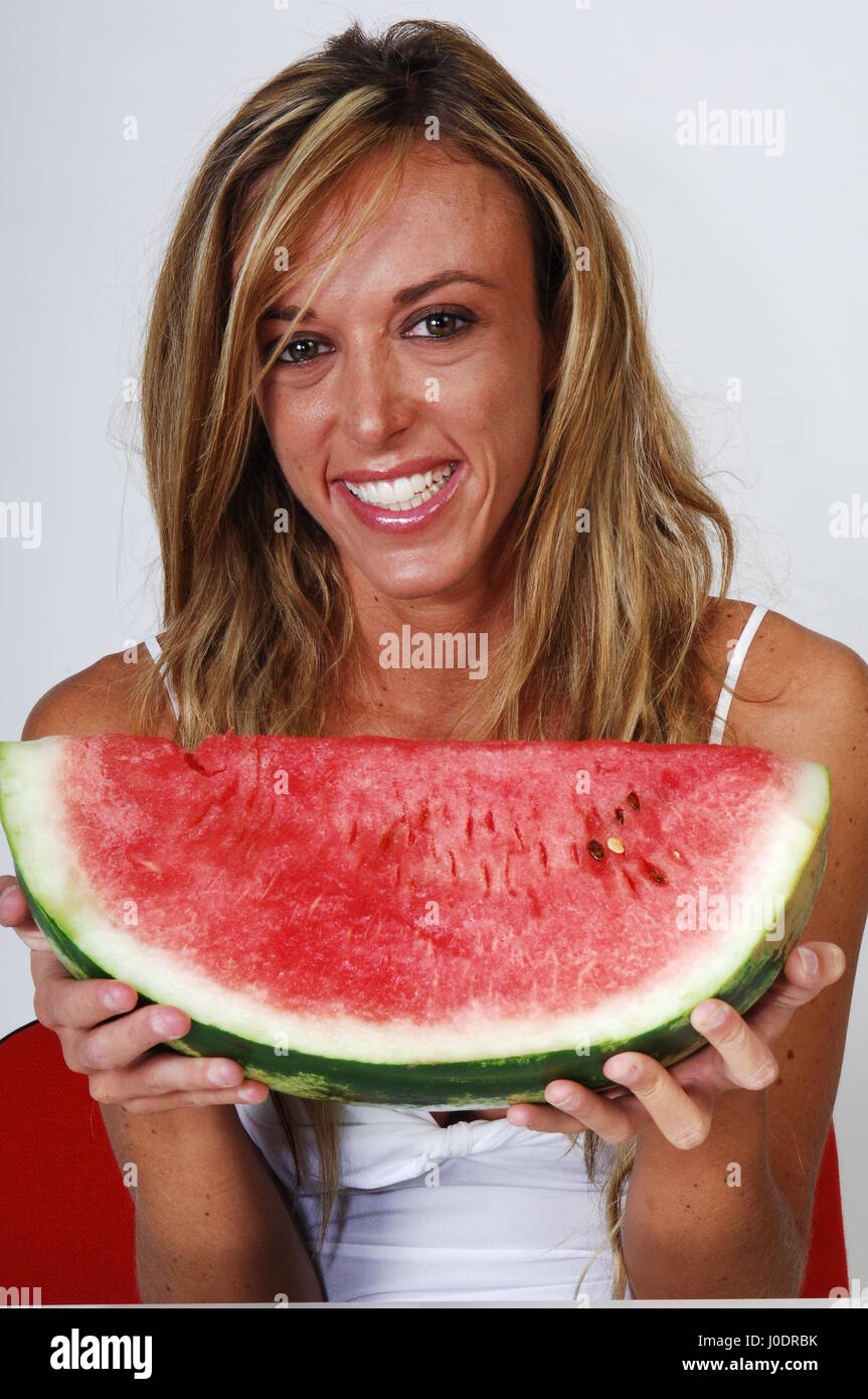 A woman eating a watermelon Stock Photo - Alamy