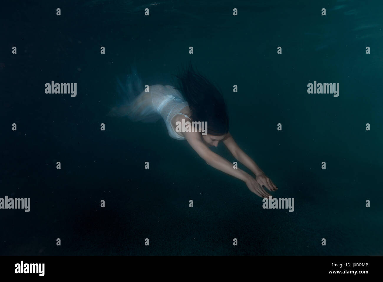 Woman mermaid swimming under water in the bottom Stock Photo - Alamy