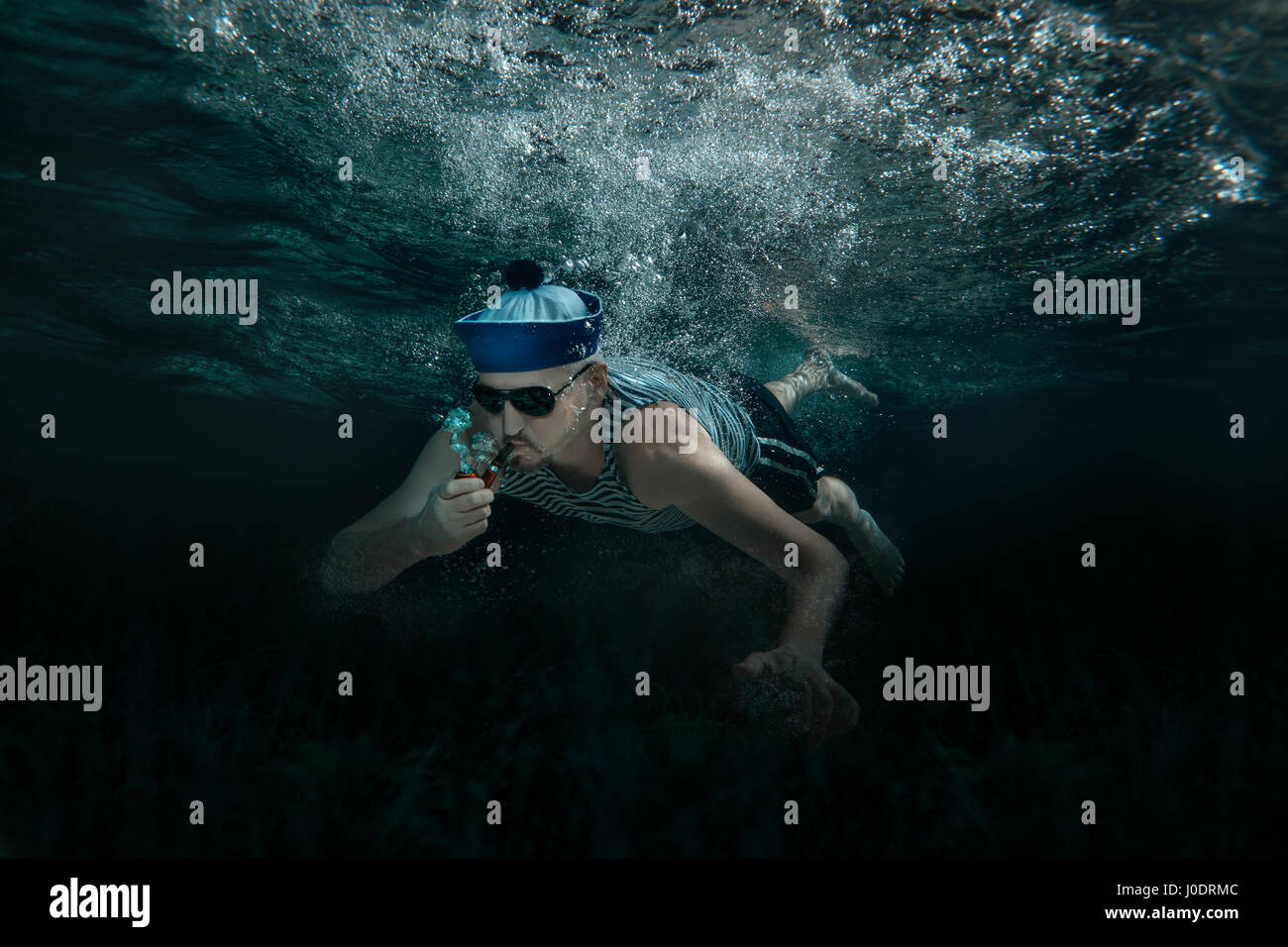 Man swimming under water and smokes a pipe Stock Photo - Alamy