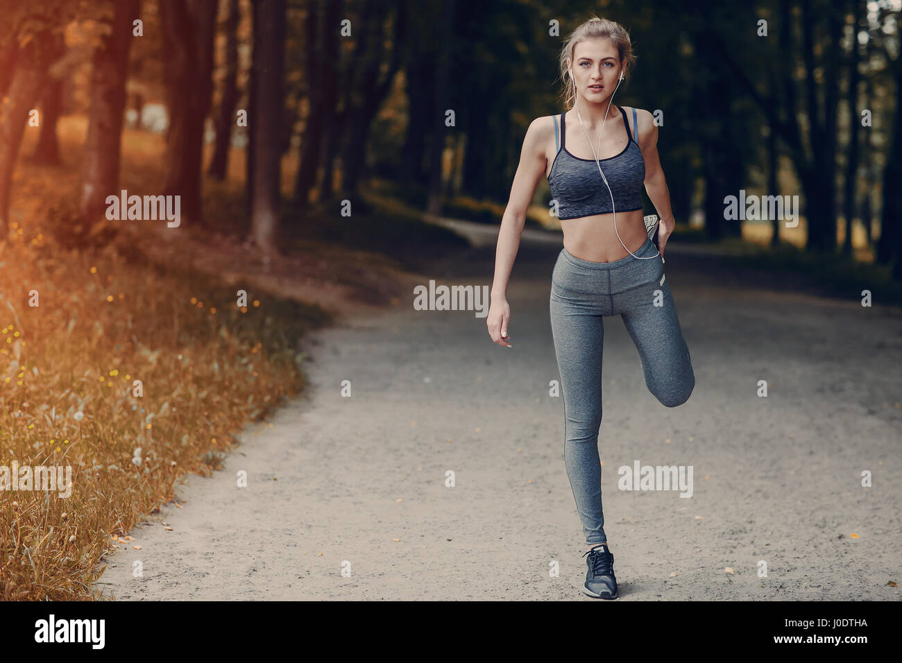 athletic girl running in the Park and doing exercises Jogging Stock ...