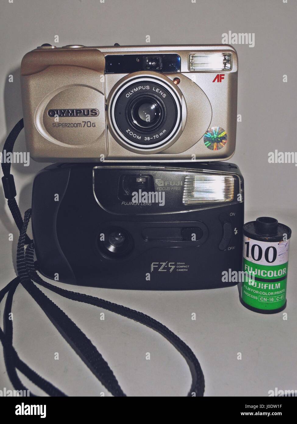 Two film cameras with a roll of film Stock Photo - Alamy