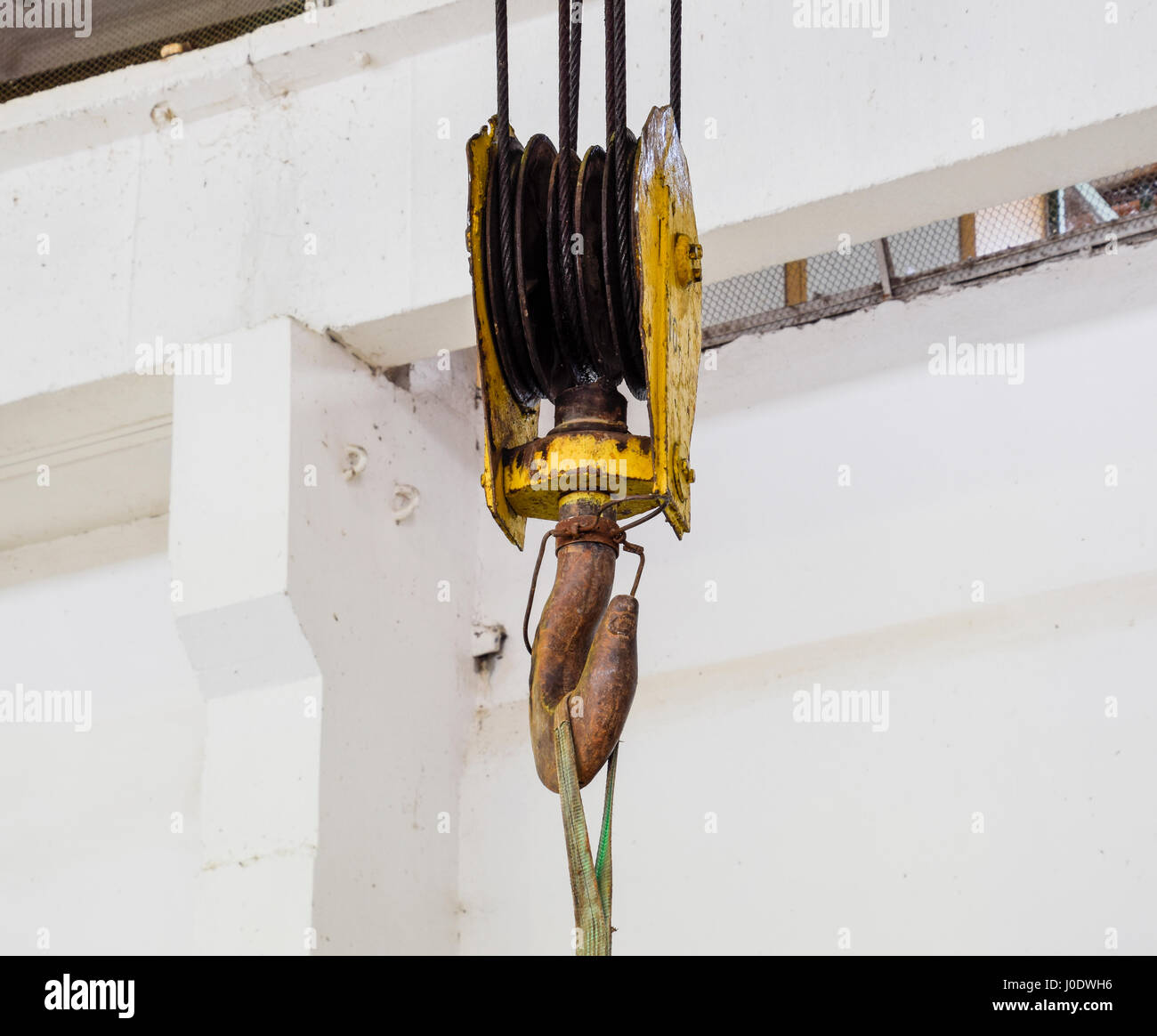 Hoist with winch and hook. A tool for moving goods in a production room ...