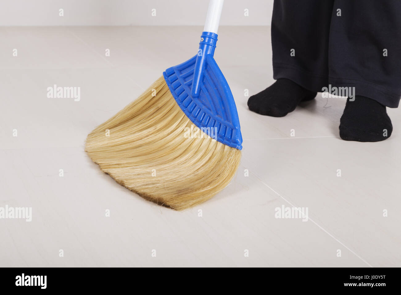 woman legs with broom sweeping the floor Stock Photo - Alamy