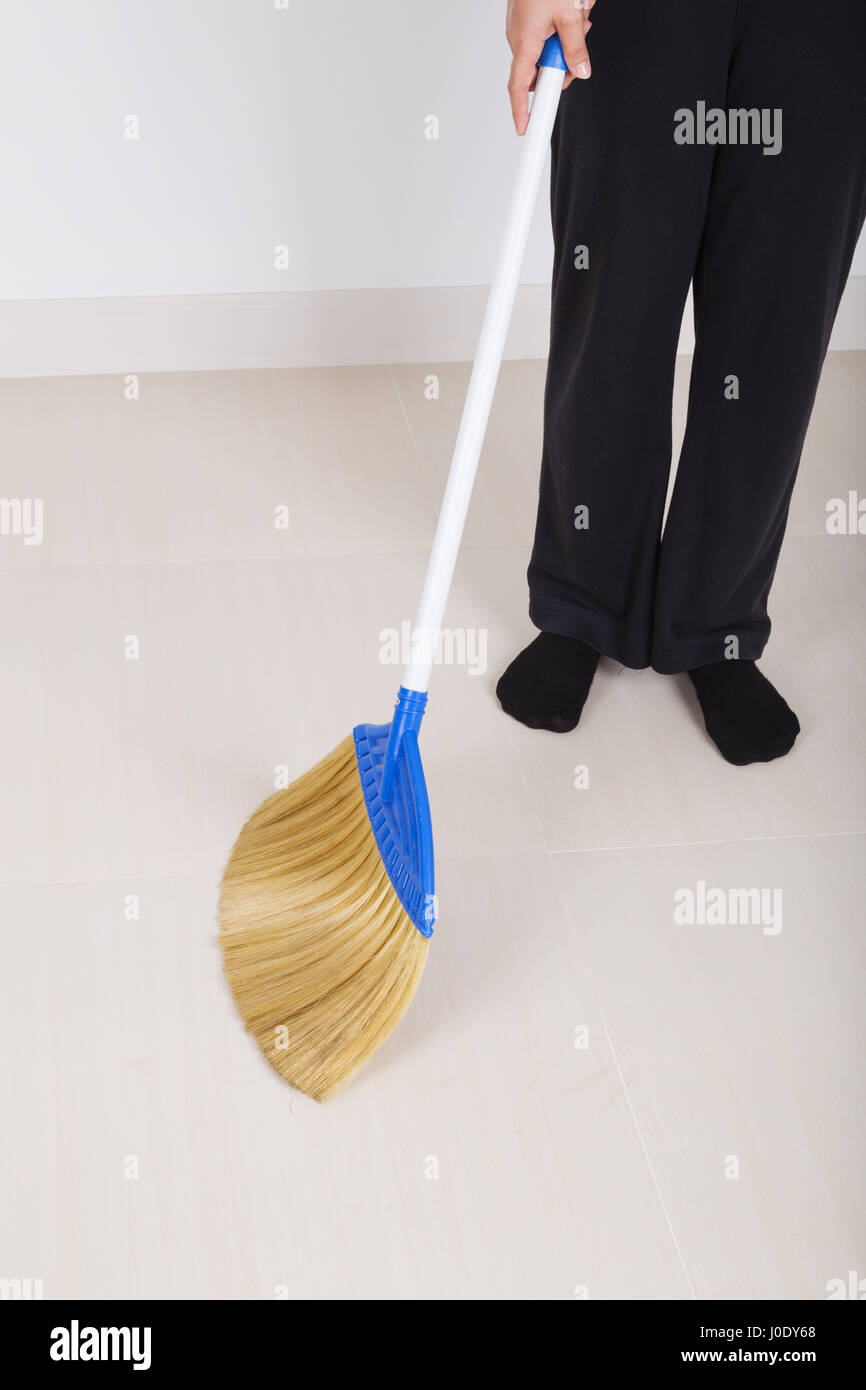 woman legs with broom sweeping the floor Stock Photo - Alamy