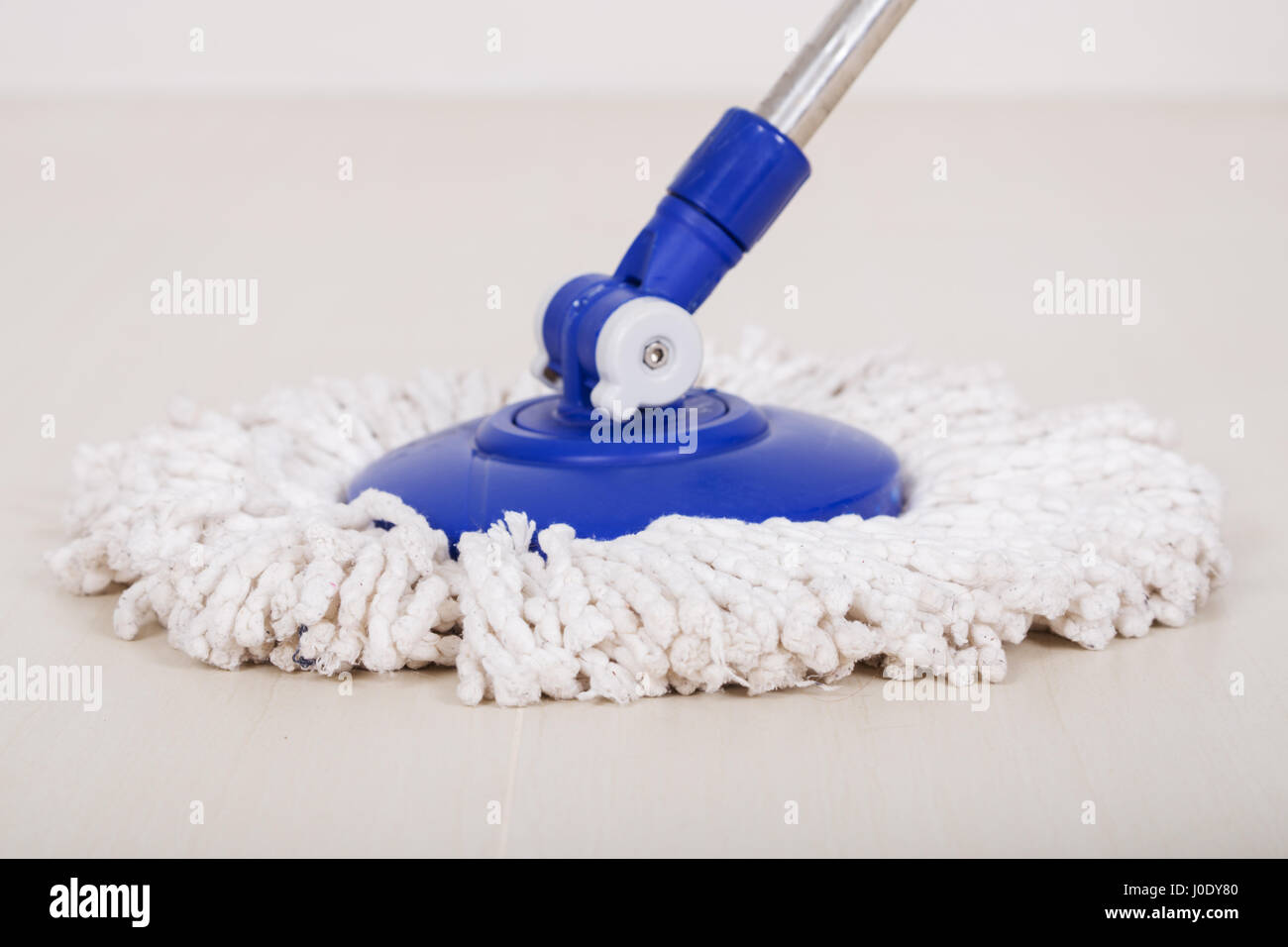 mop for cleaning with the floor background Stock Photo - Alamy