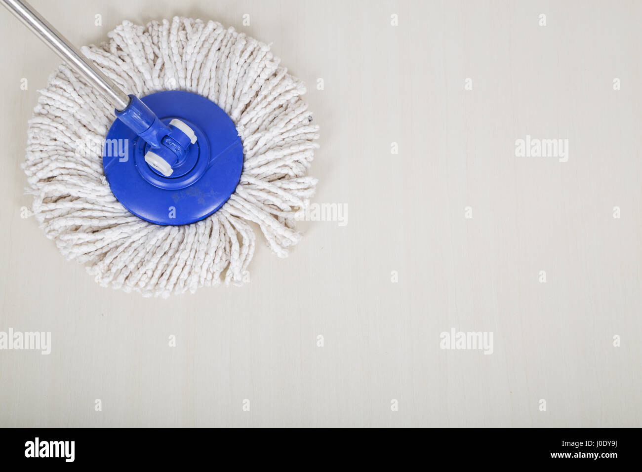 mop for cleaning with the floor background Stock Photo - Alamy