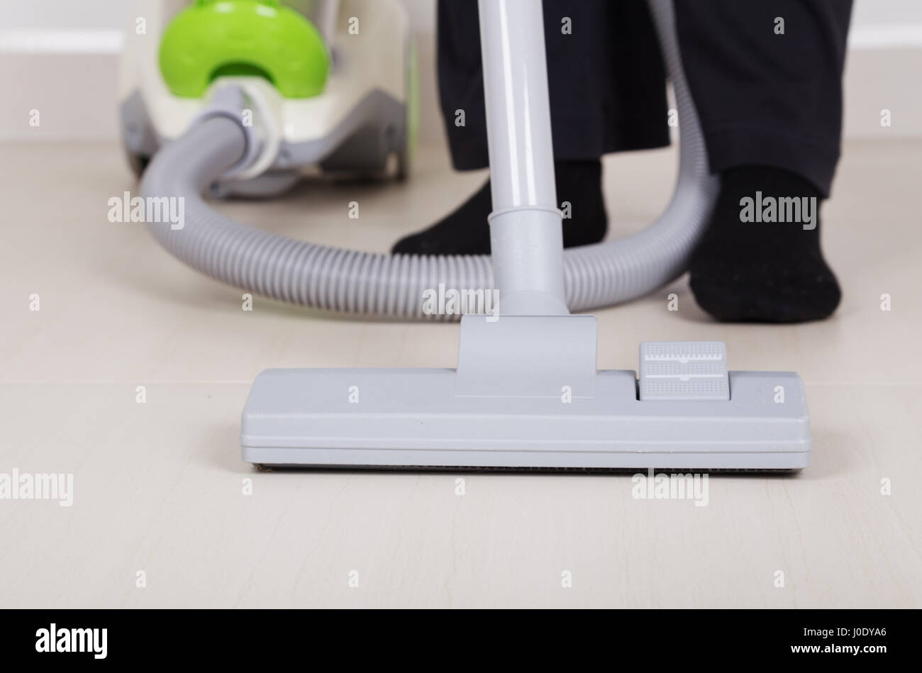 woman legs with vacuum cleaner cleaning floor at home Stock Photo - Alamy