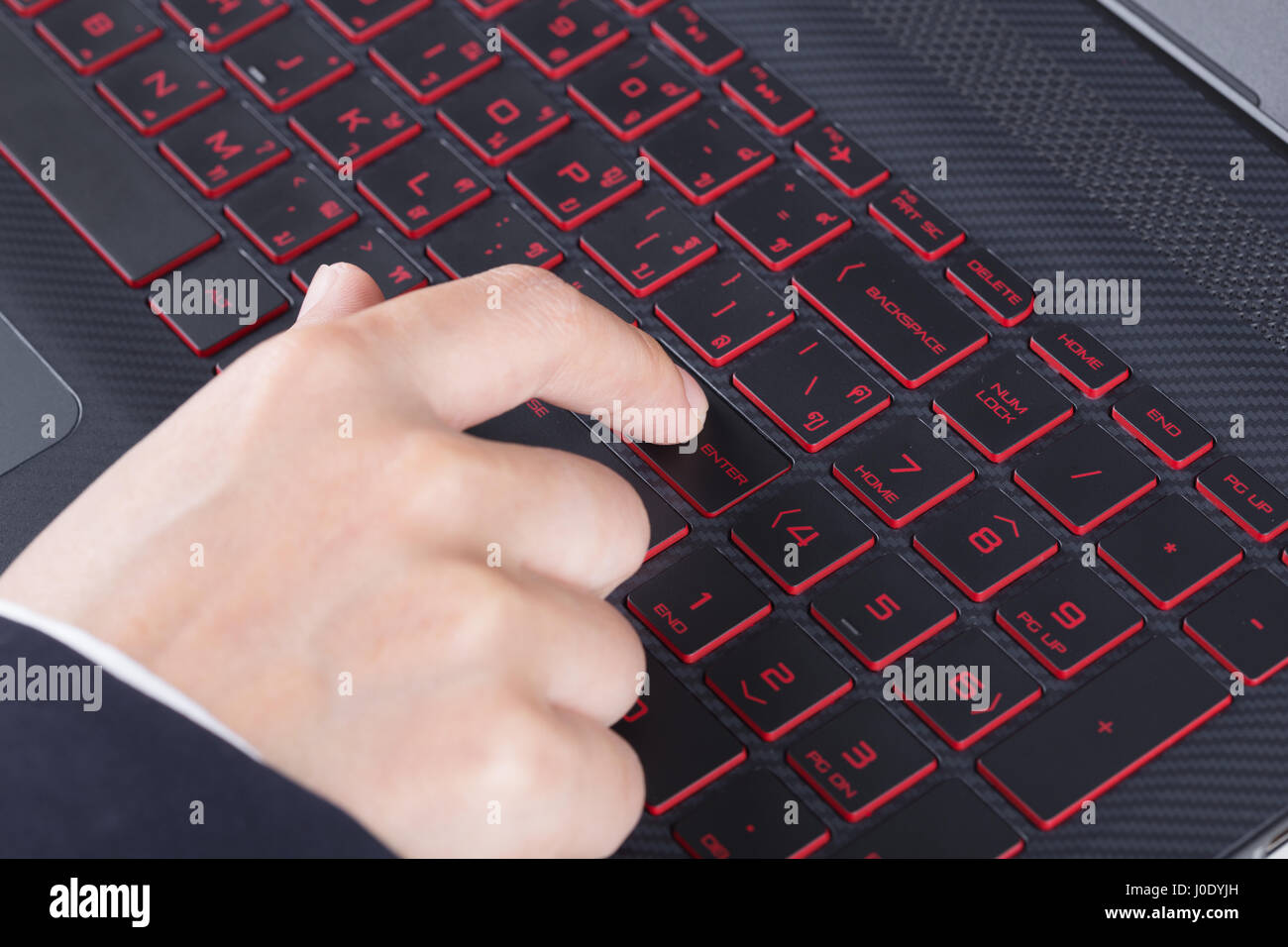 finger pushing enter button on a laptop keyboard Stock Photo - Alamy