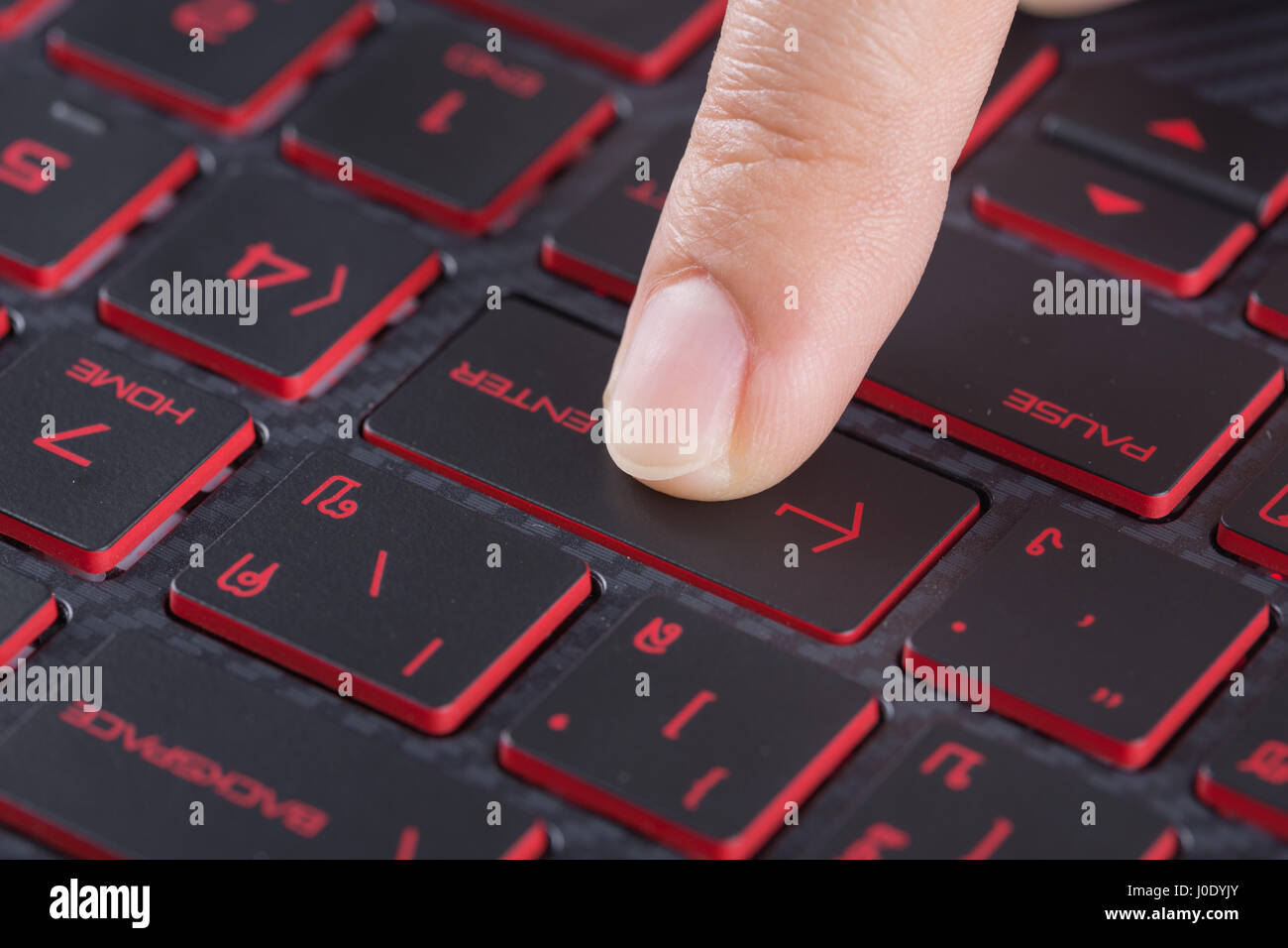 finger pushing enter button on a laptop keyboard Stock Photo - Alamy