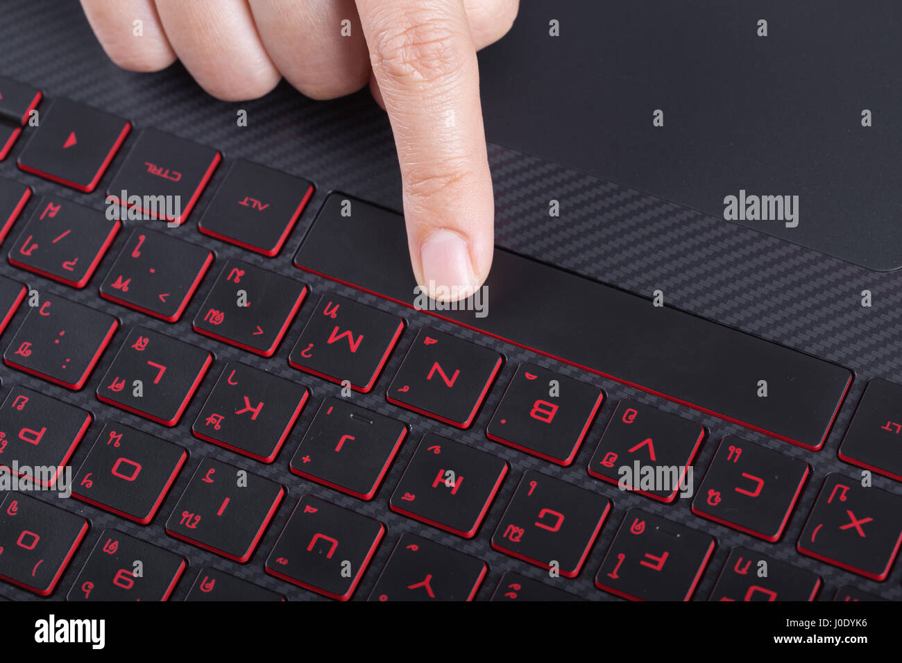 finger pushing space bar button on a laptop keyboard Stock Photo - Alamy