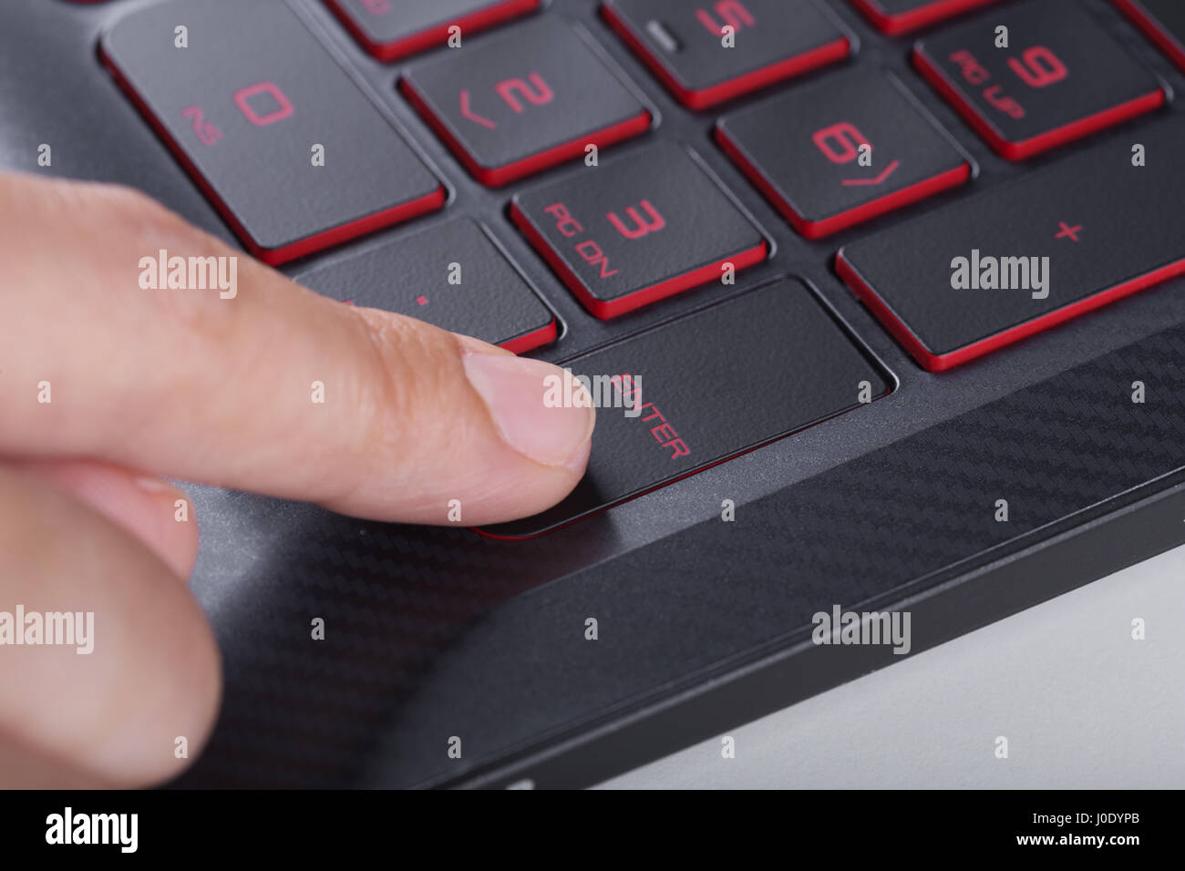 finger pushing enter button on a laptop keyboard Stock Photo - Alamy