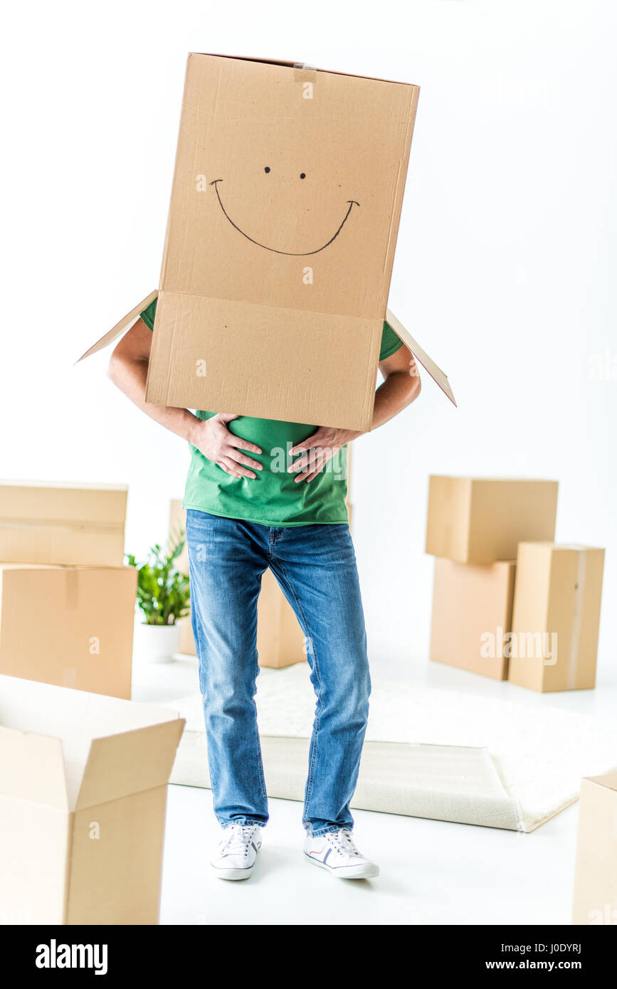 Man putting cardboard box on head with smiley drawed on it Stock Photo ...