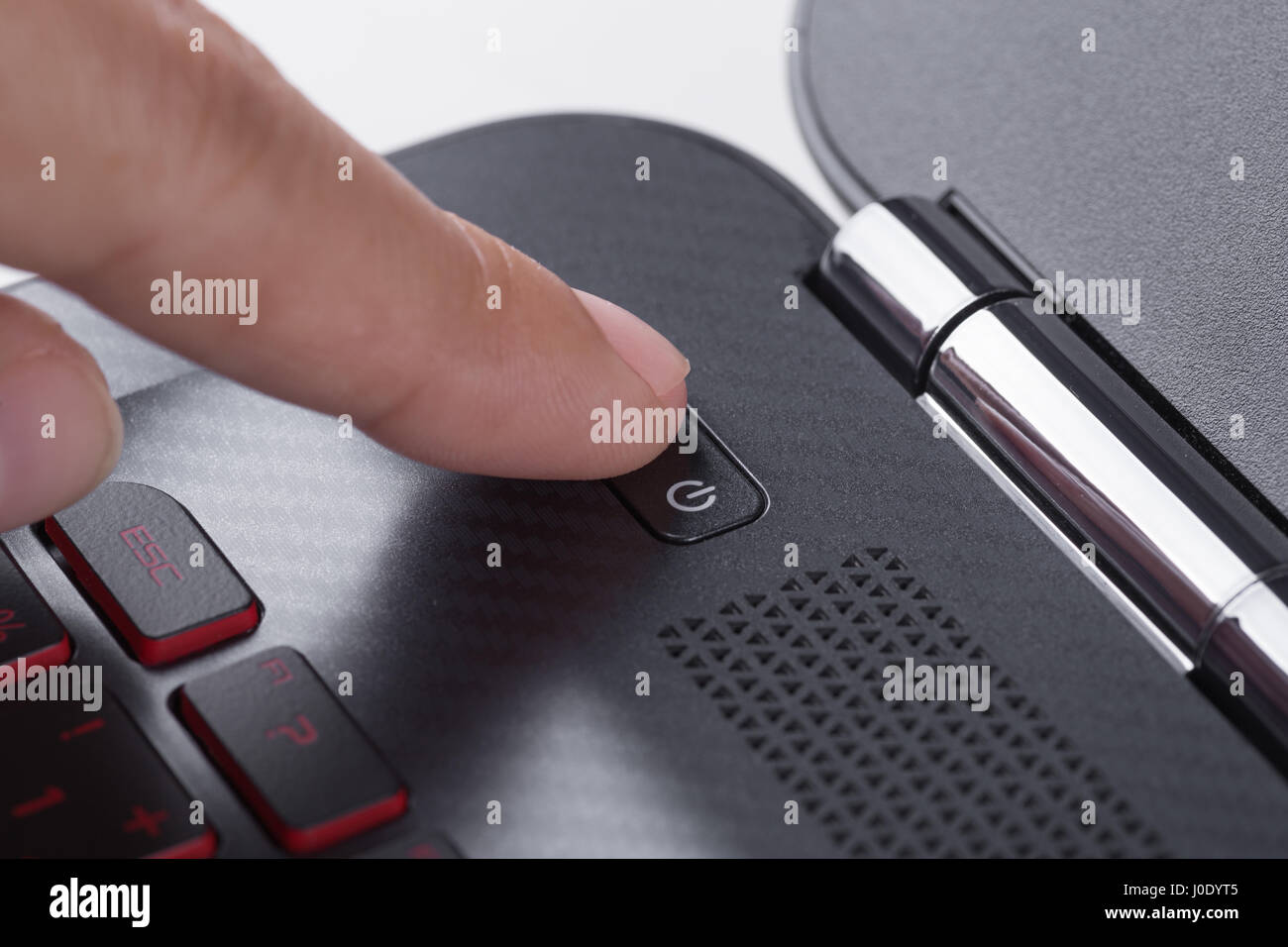 finger pushing power button on a laptop keyboard Stock Photo - Alamy