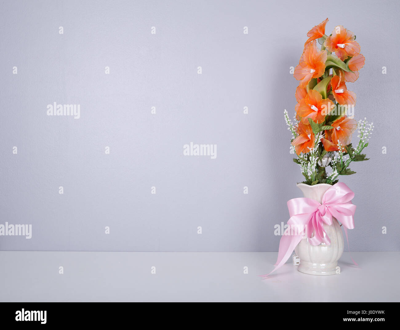 electric flower in vase on table with wall background Stock Photo - Alamy