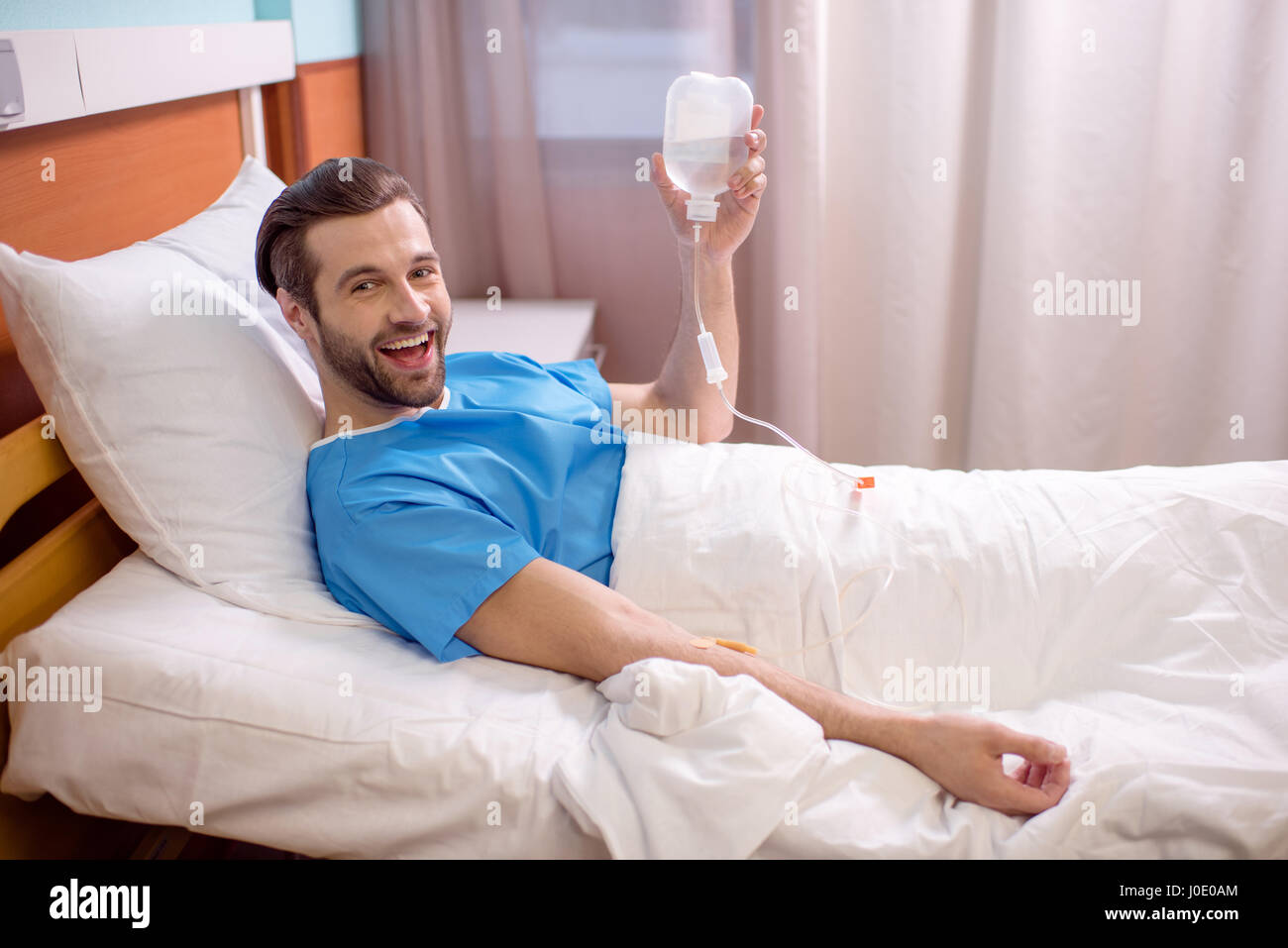 Man laughing hospital bed hi-res stock photography and images - Alamy