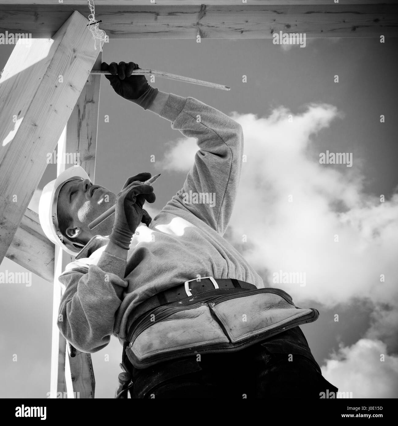carpenter with tools working on timber construction Stock Photo - Alamy
