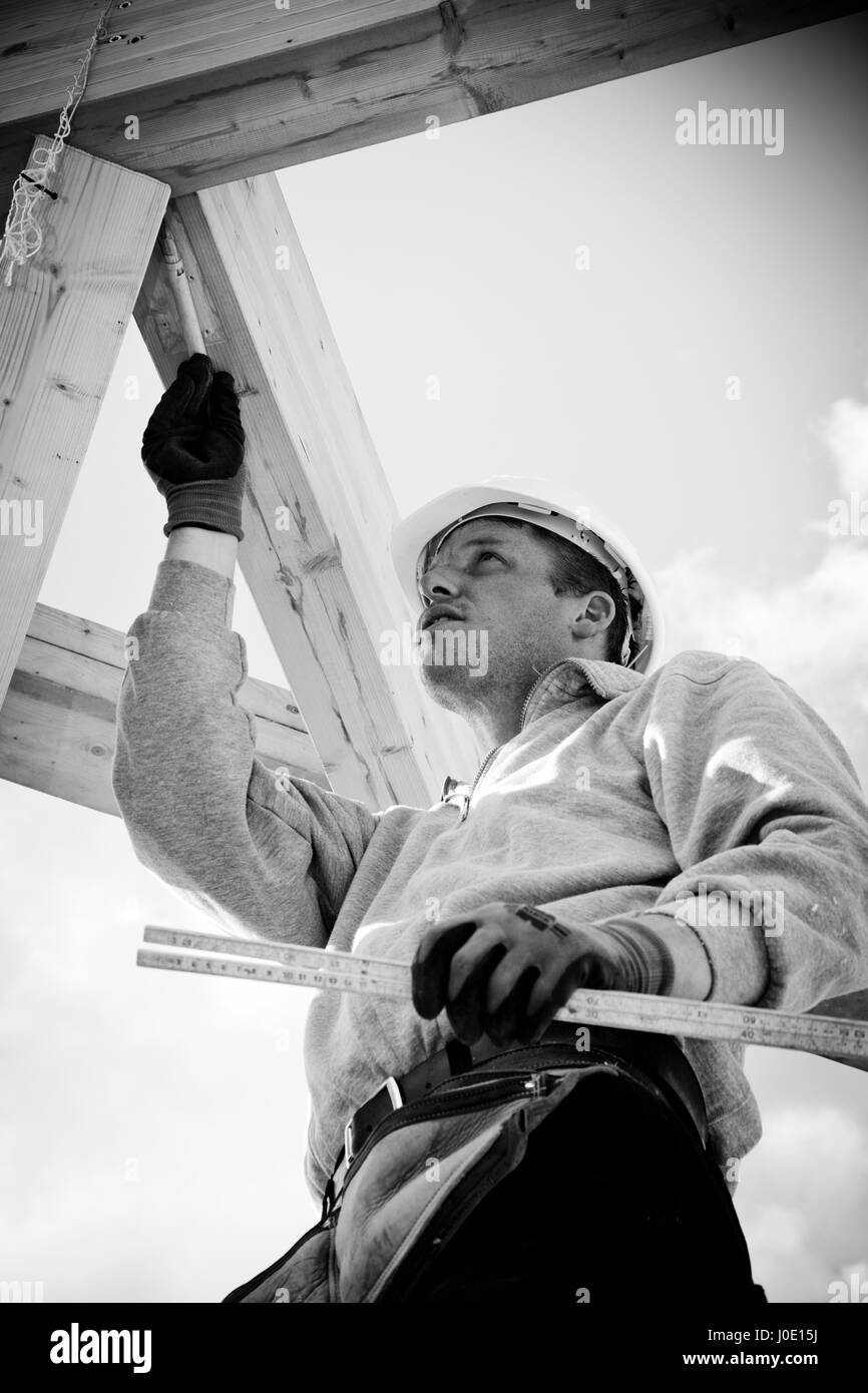 carpenter with tools working on timber construction Stock Photo - Alamy