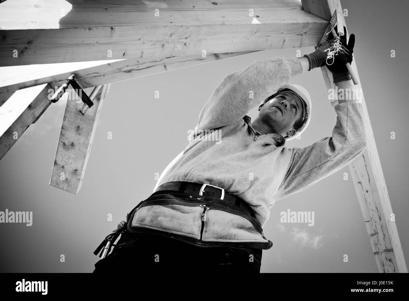 carpenter with tools working on timber construction Stock Photo - Alamy