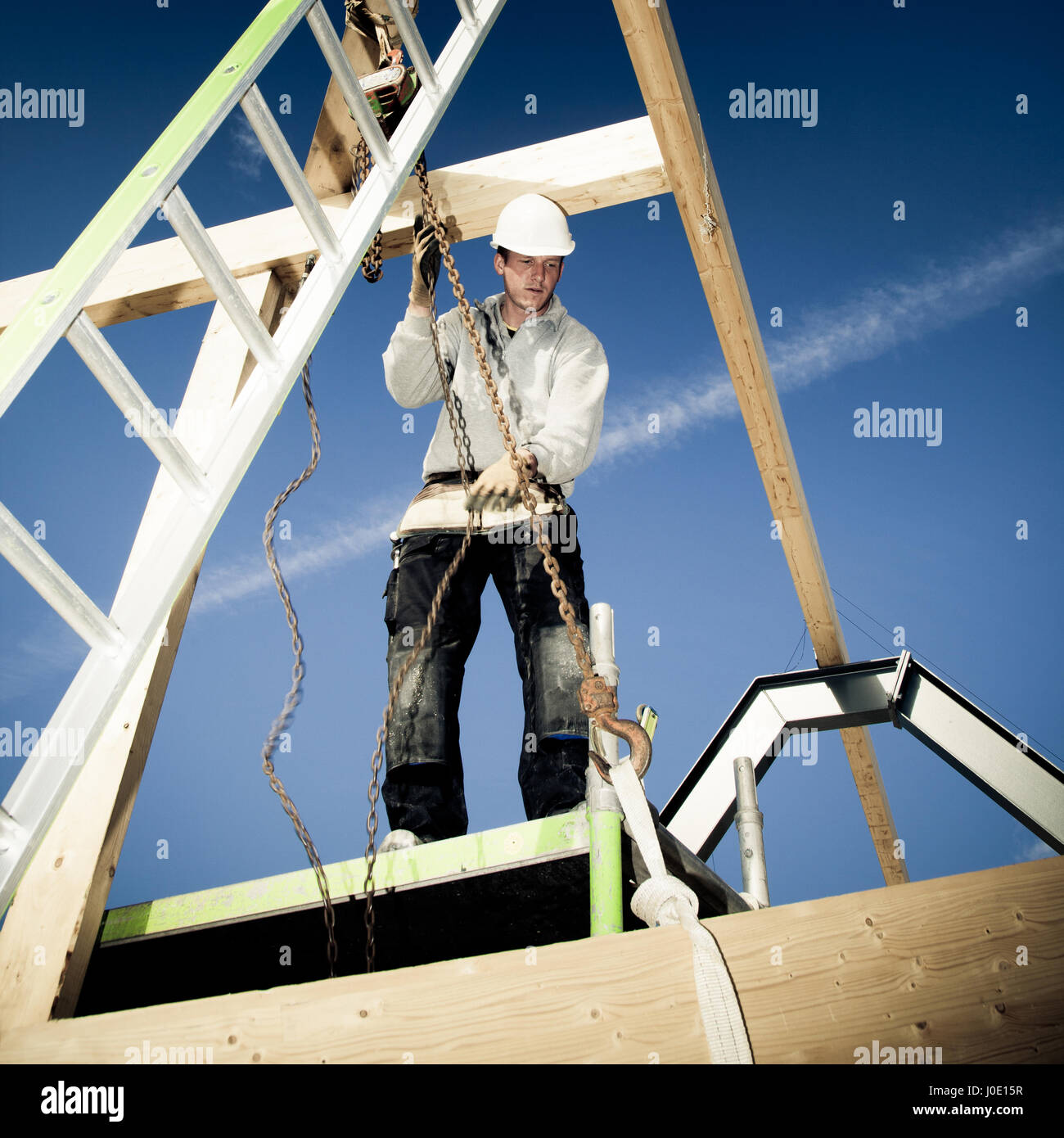 construction worker with ladder and winch on top of construction Stock ...