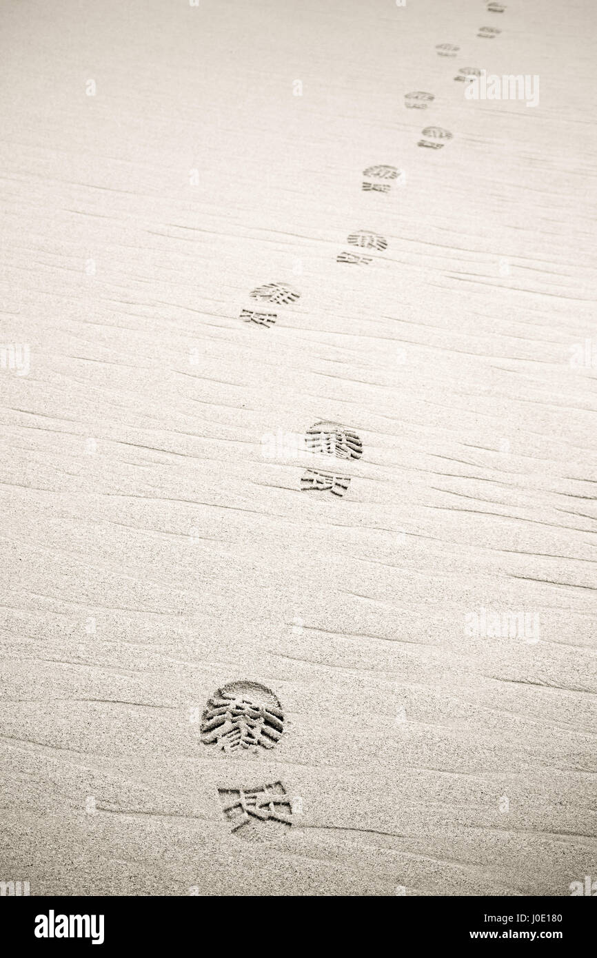 Footprints hiking boots on beach. Monochrome Stock Photo - Alamy