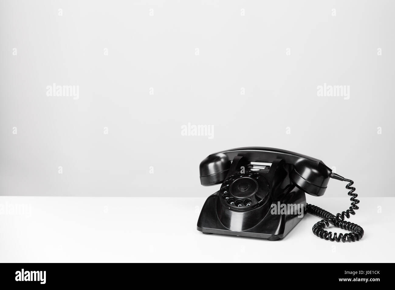 Old Vintage Black Telephone with grey background Stock Photo - Alamy