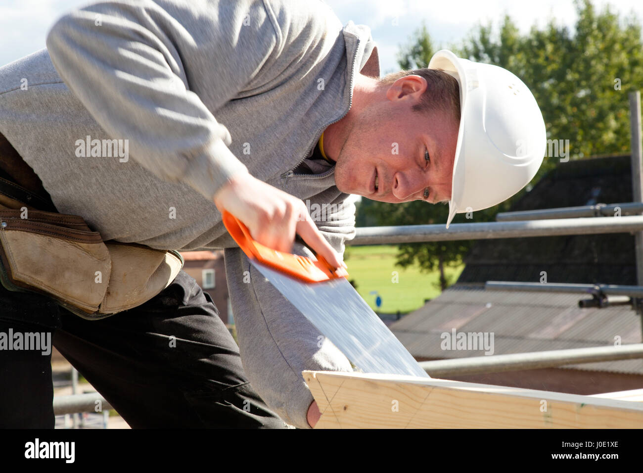 carpenter at work with wooden construction Stock Photo - Alamy