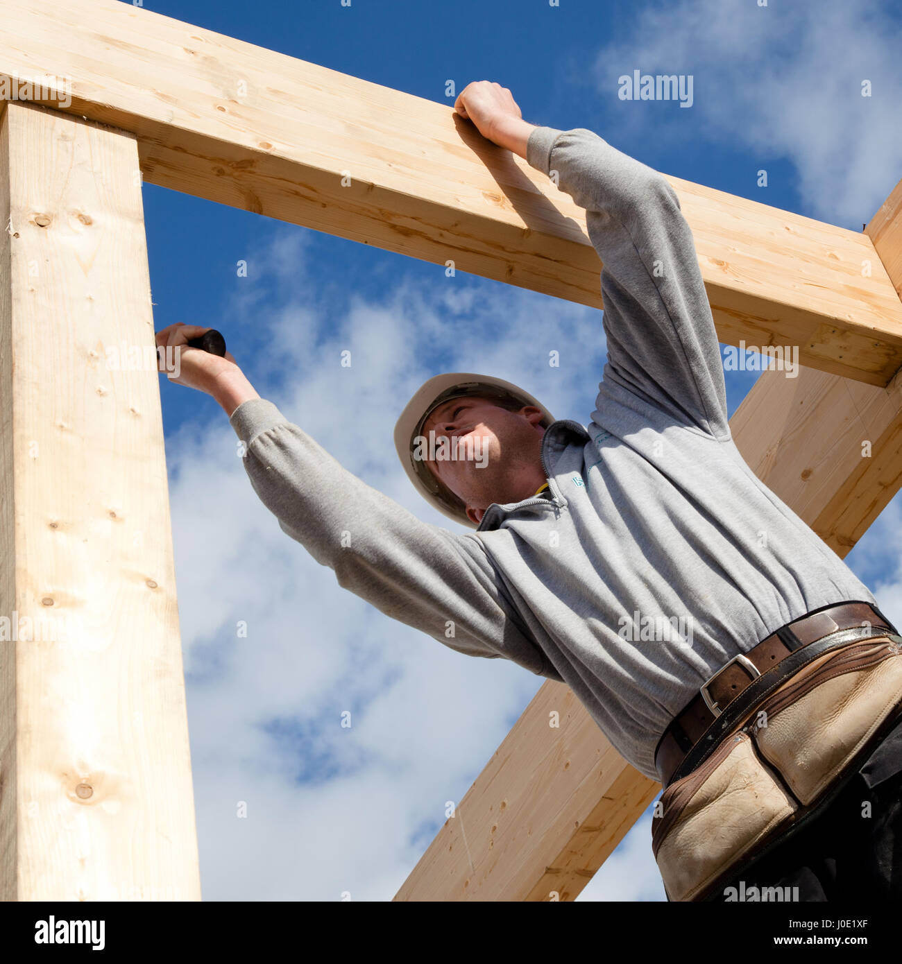 carpenter at work with wooden roof construction Stock Photo - Alamy