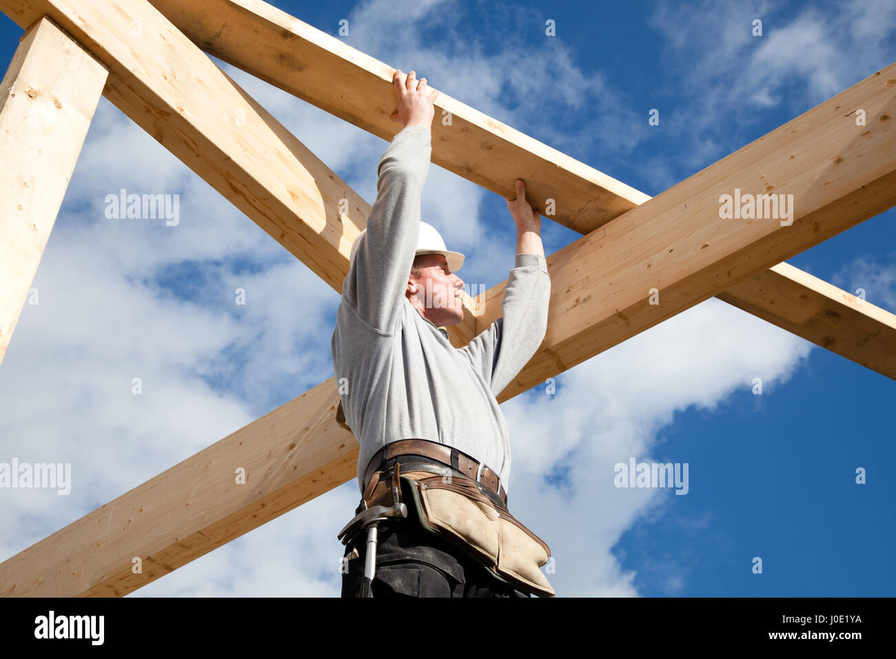 carpenter at work with wooden roof construction Stock Photo - Alamy