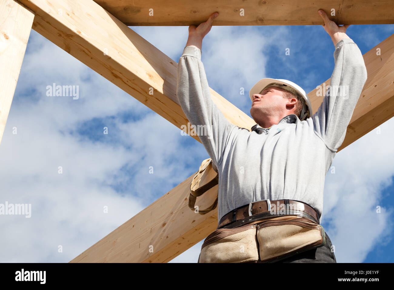 carpenter at work with wooden roof construction Stock Photo - Alamy