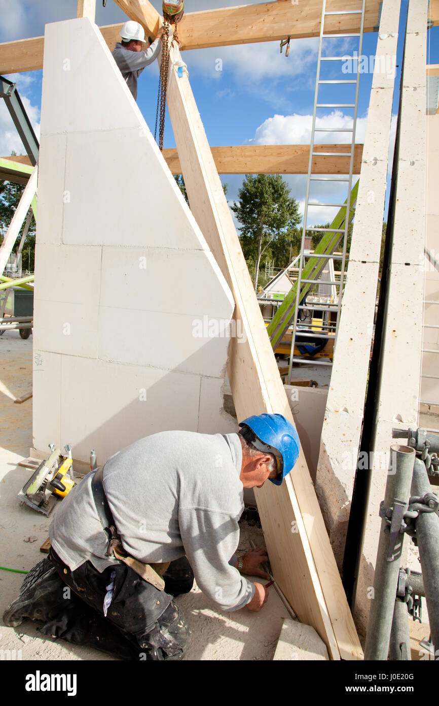 carpenter at work with wooden roof construction Stock Photo - Alamy
