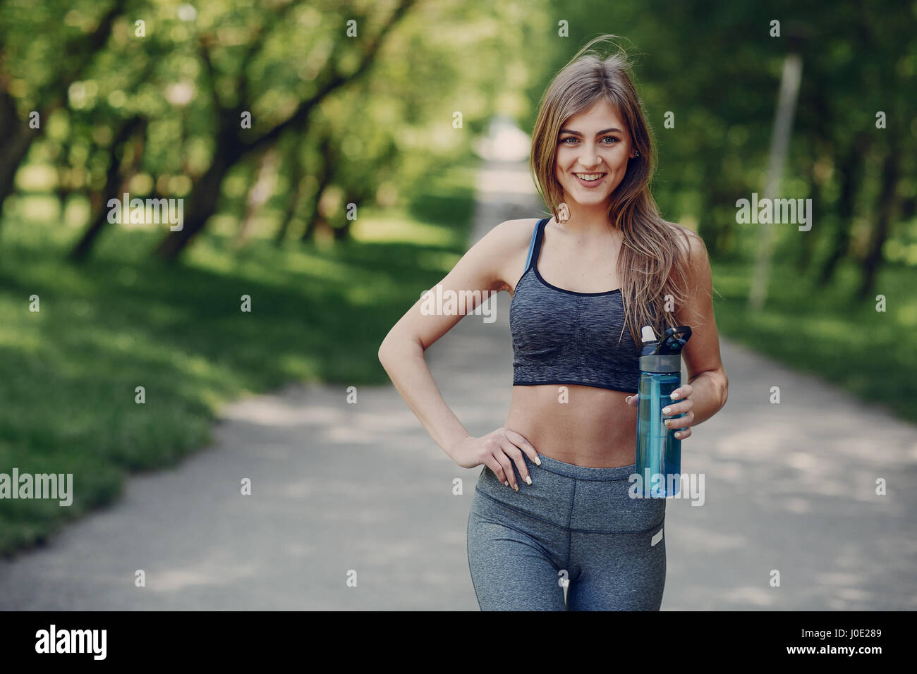 athletic girl running in the Park and doing exercises Jogging Stock ...