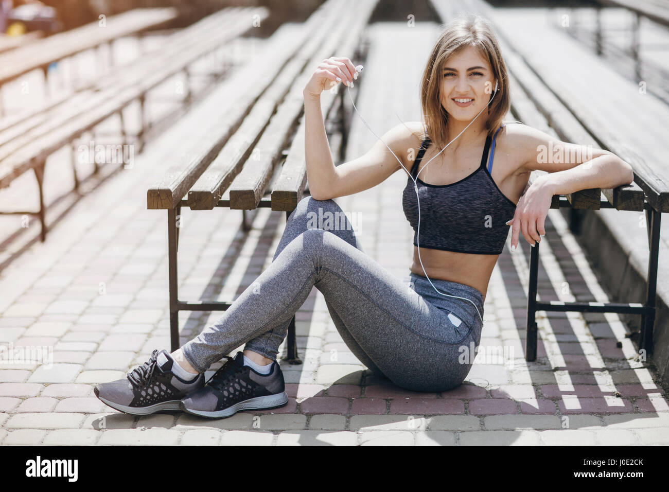 athletic girl running in the Park and doing exercises Jogging Stock ...