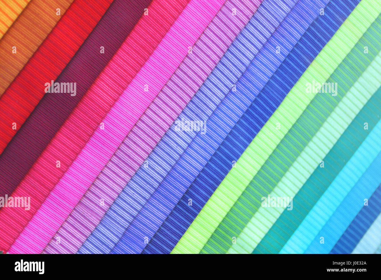 Colored fabric brochure in a diagonal position. Textured background ...